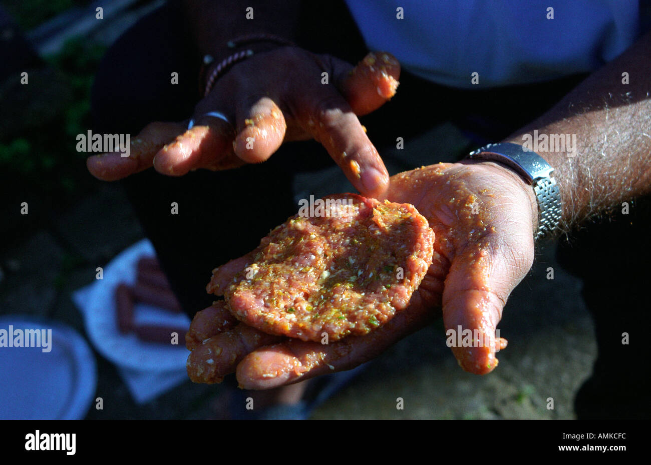 A man making a hand made burger for a barbecue in Leicester England UK ...