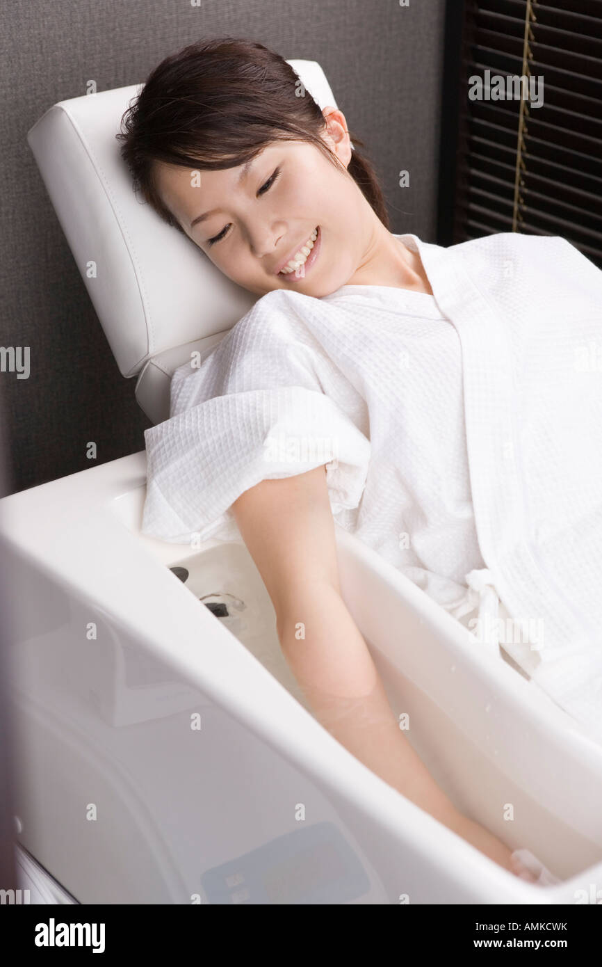 Young woman having hand bath Stock Photo - Alamy