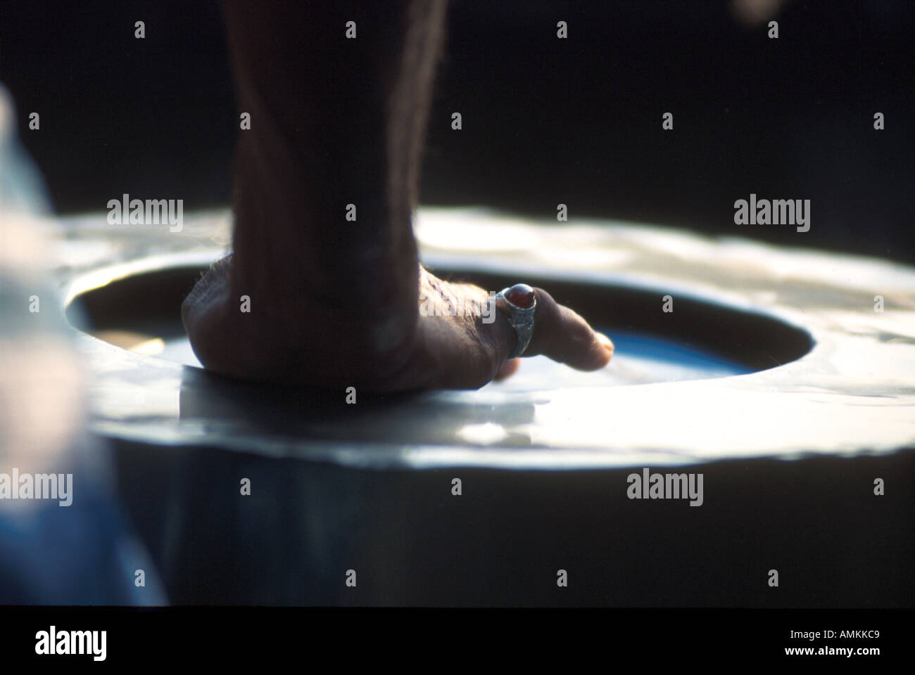 A washermans hand controling the hand operated spinner to get the water ...