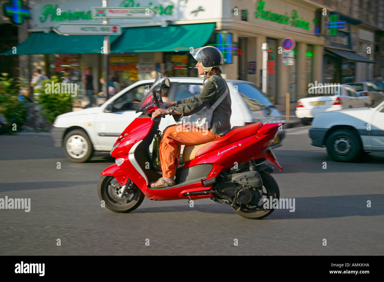 Man riding moped in Nice France Stock Photo - Alamy