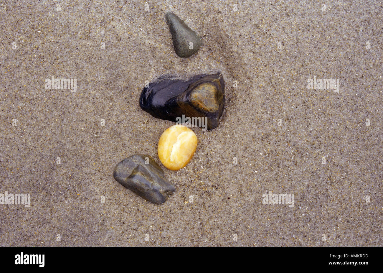 Small stones in beach sand Stock Photo - Alamy