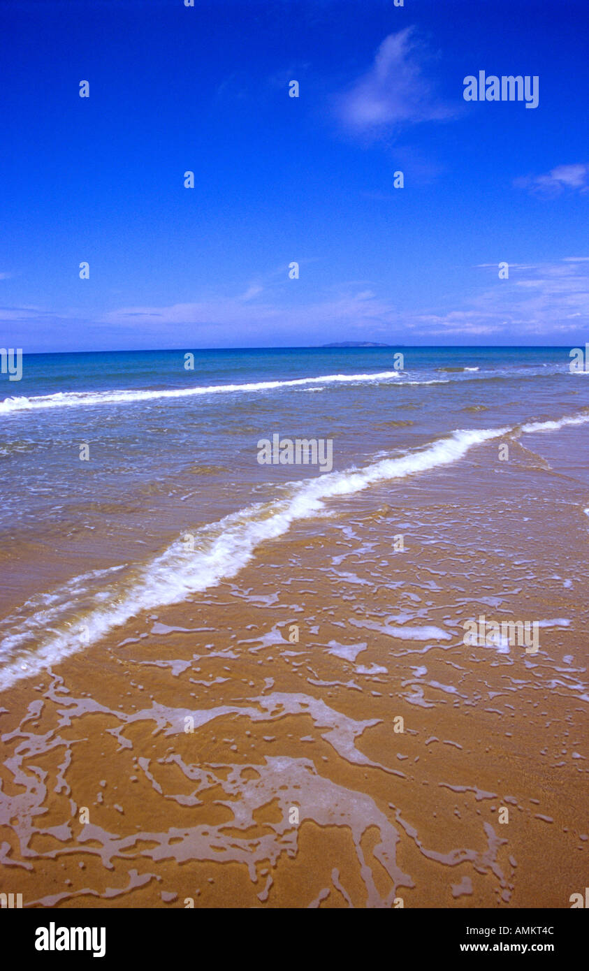 San Stefanos Beach, Corfu in summer under blue sky with lapping waves ...