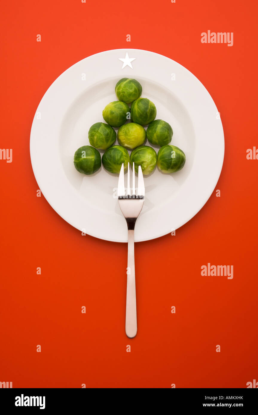 Brussels sprouts in a Christmas tree shape with a silver fork trunk on ...