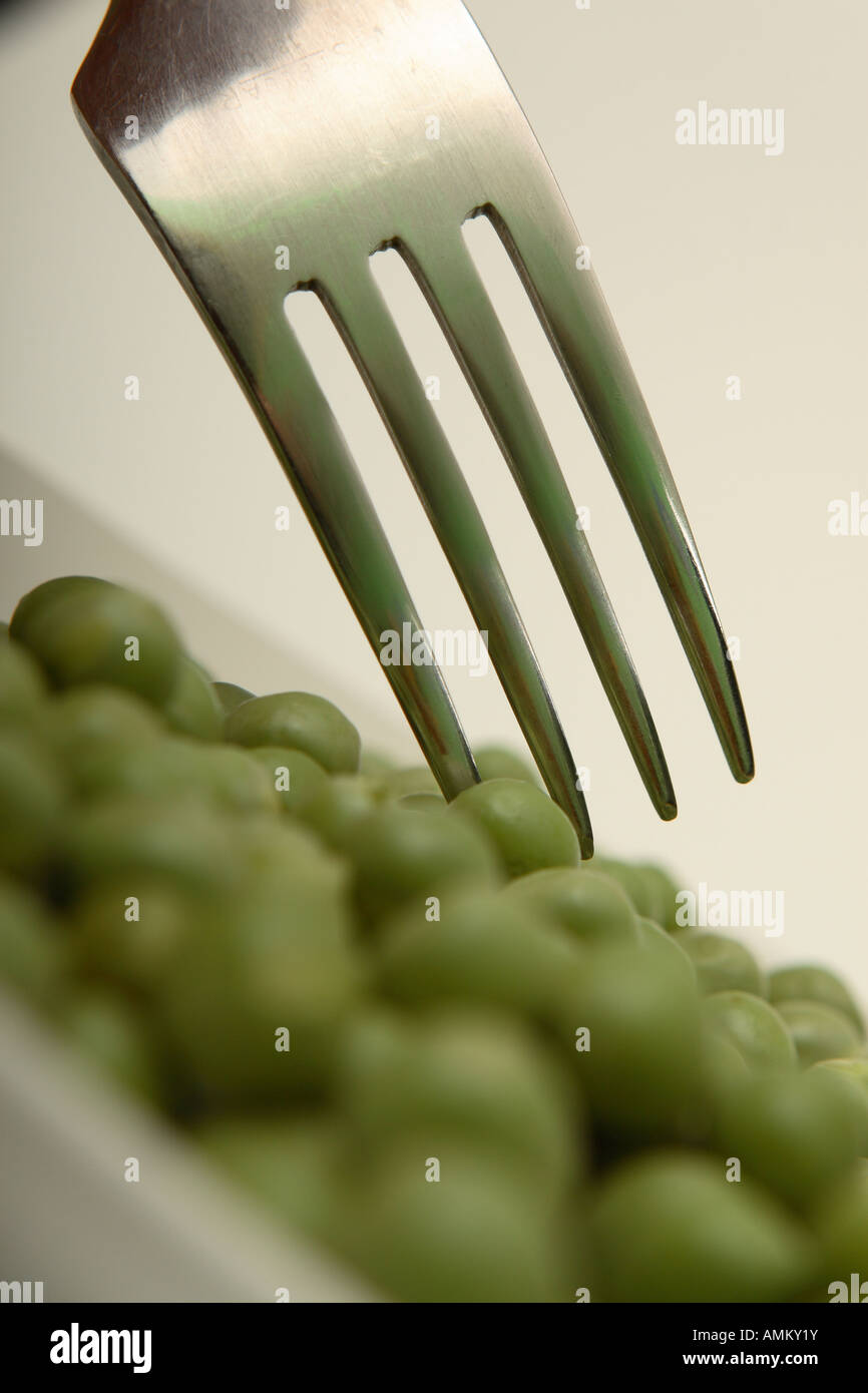 Fresh peas vegetable and fork eating Stock Photo - Alamy