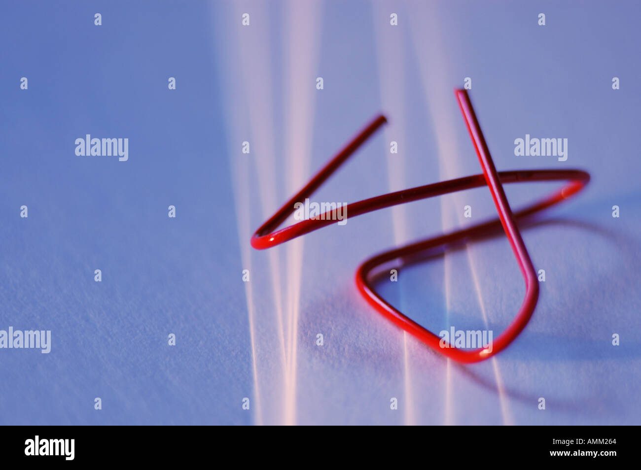 Twisted paperclip and paper Stock Photo - Alamy