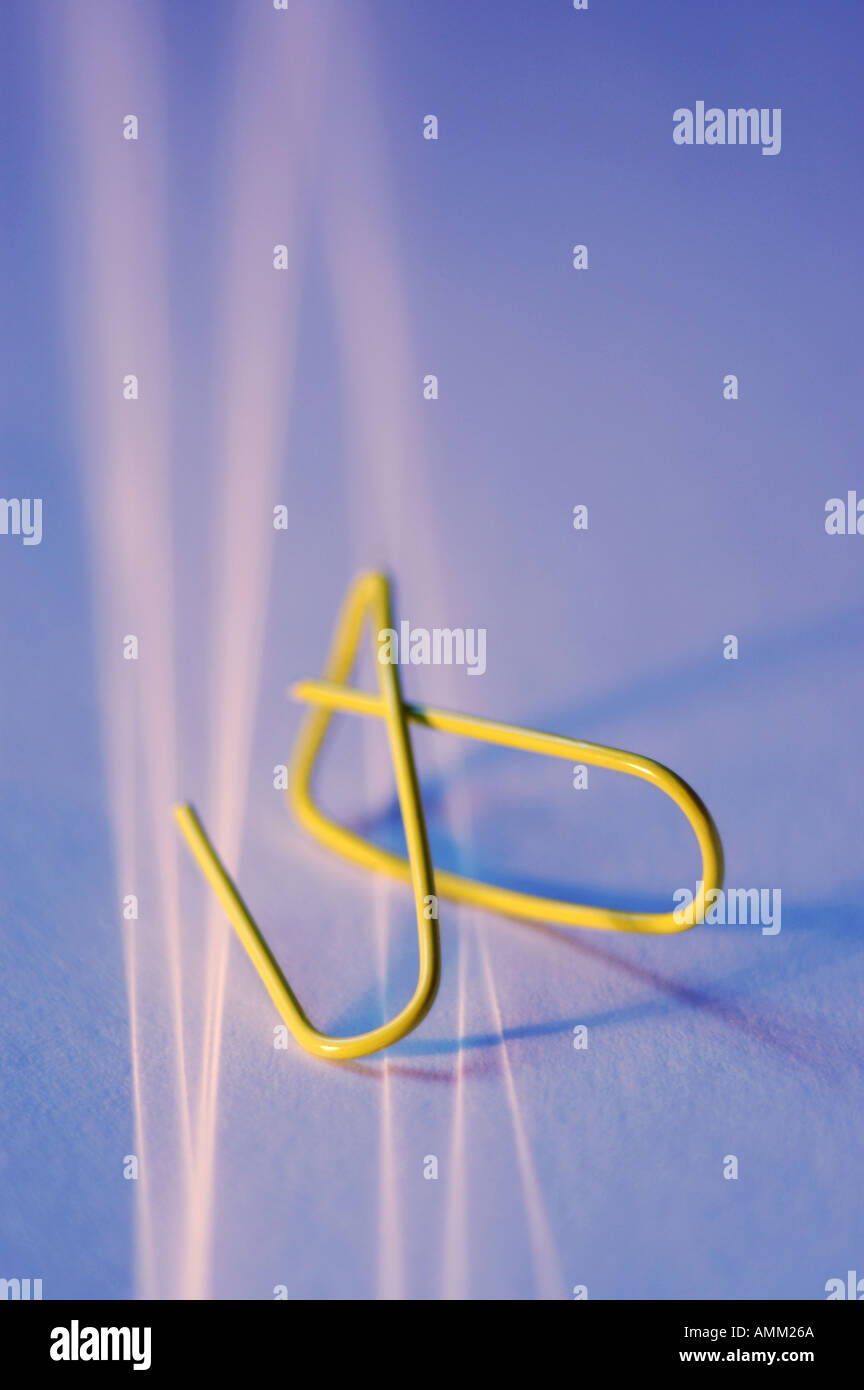 Twisted paperclip and paper Stock Photo - Alamy
