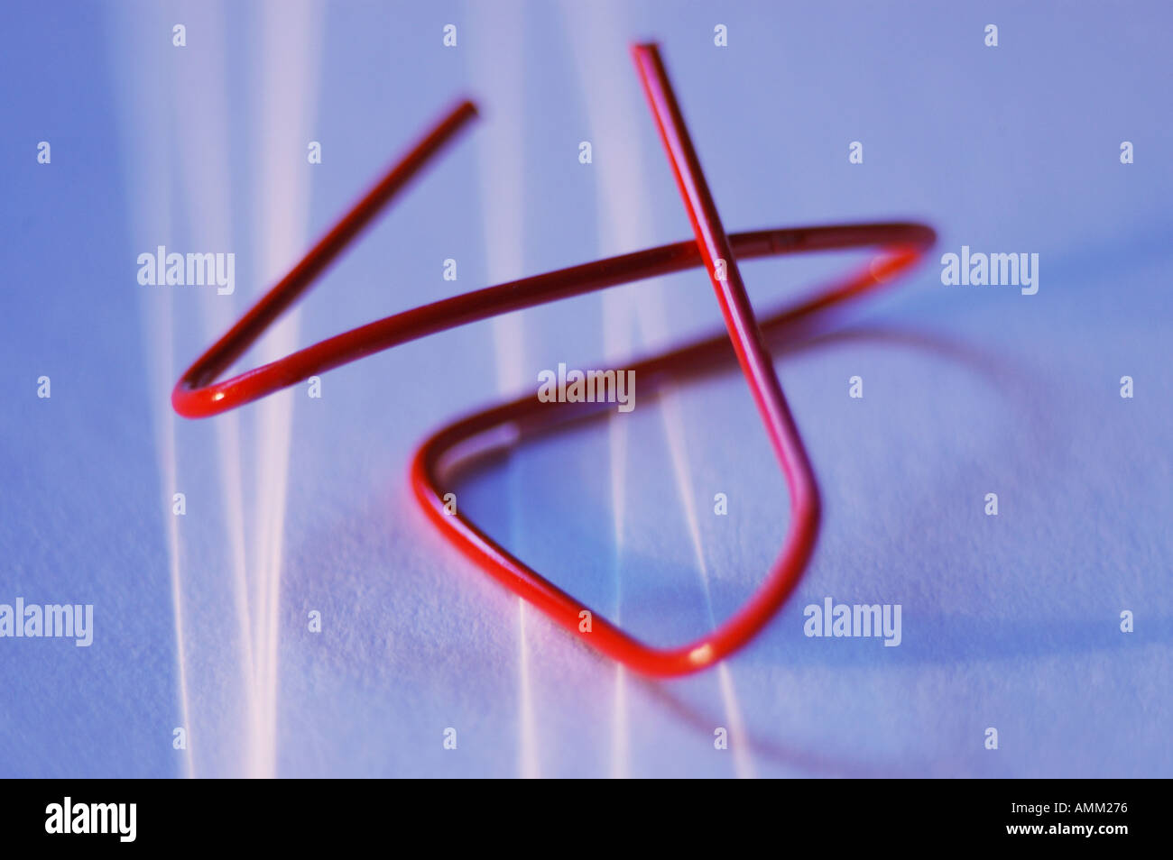 Twisted paperclip and paper Stock Photo - Alamy