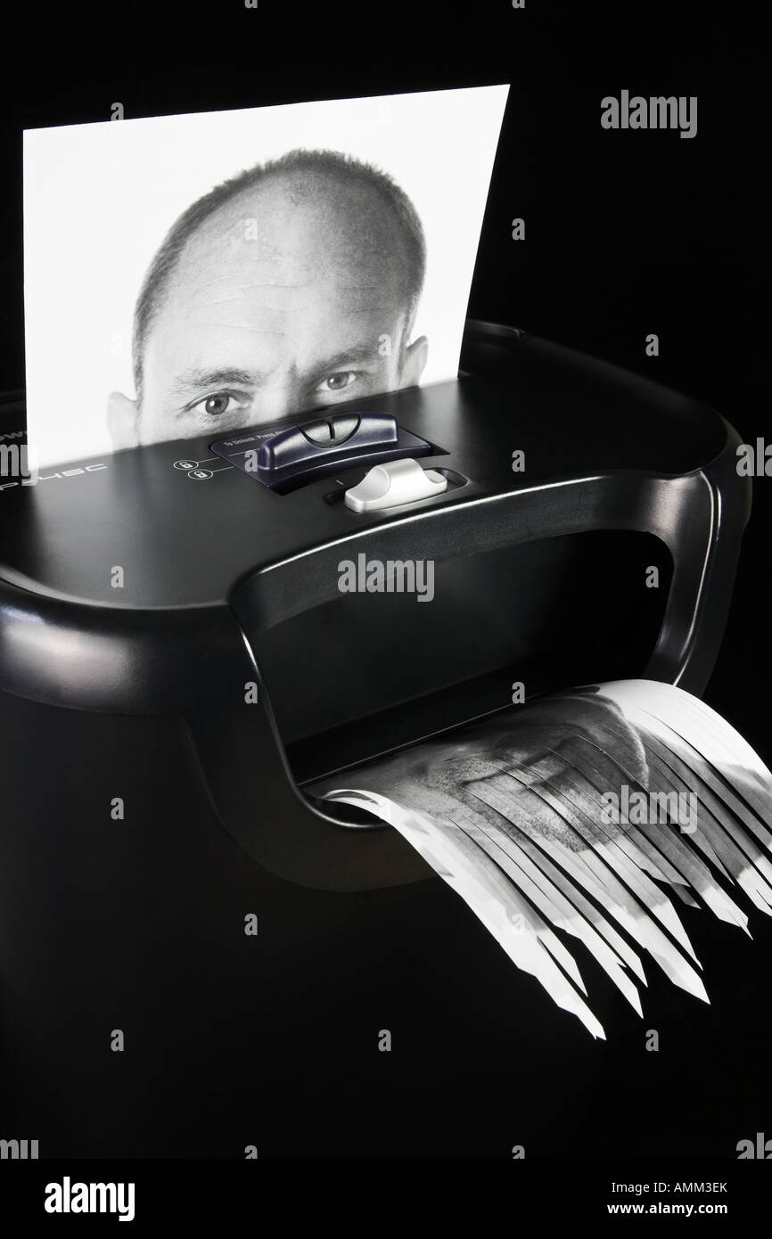 Photograph of a man s face being put through a paper shredder Stock ...