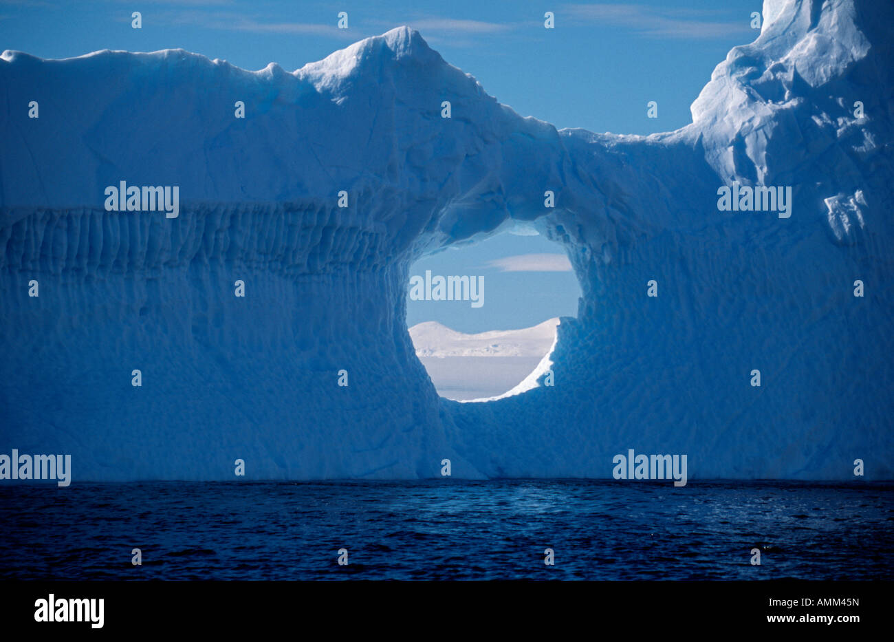 Weathered iceberg with a circular window near Booth Island Stock Photo ...