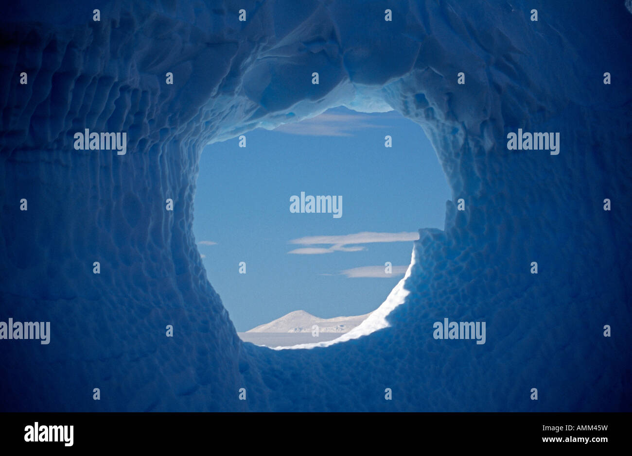 Weathered iceberg with a circular window near Booth Island Stock Photo ...