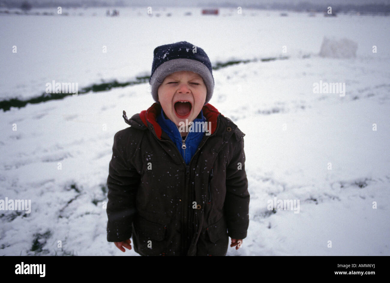 a young boy cold in the snow, Blackheath London Stock Photo - Alamy