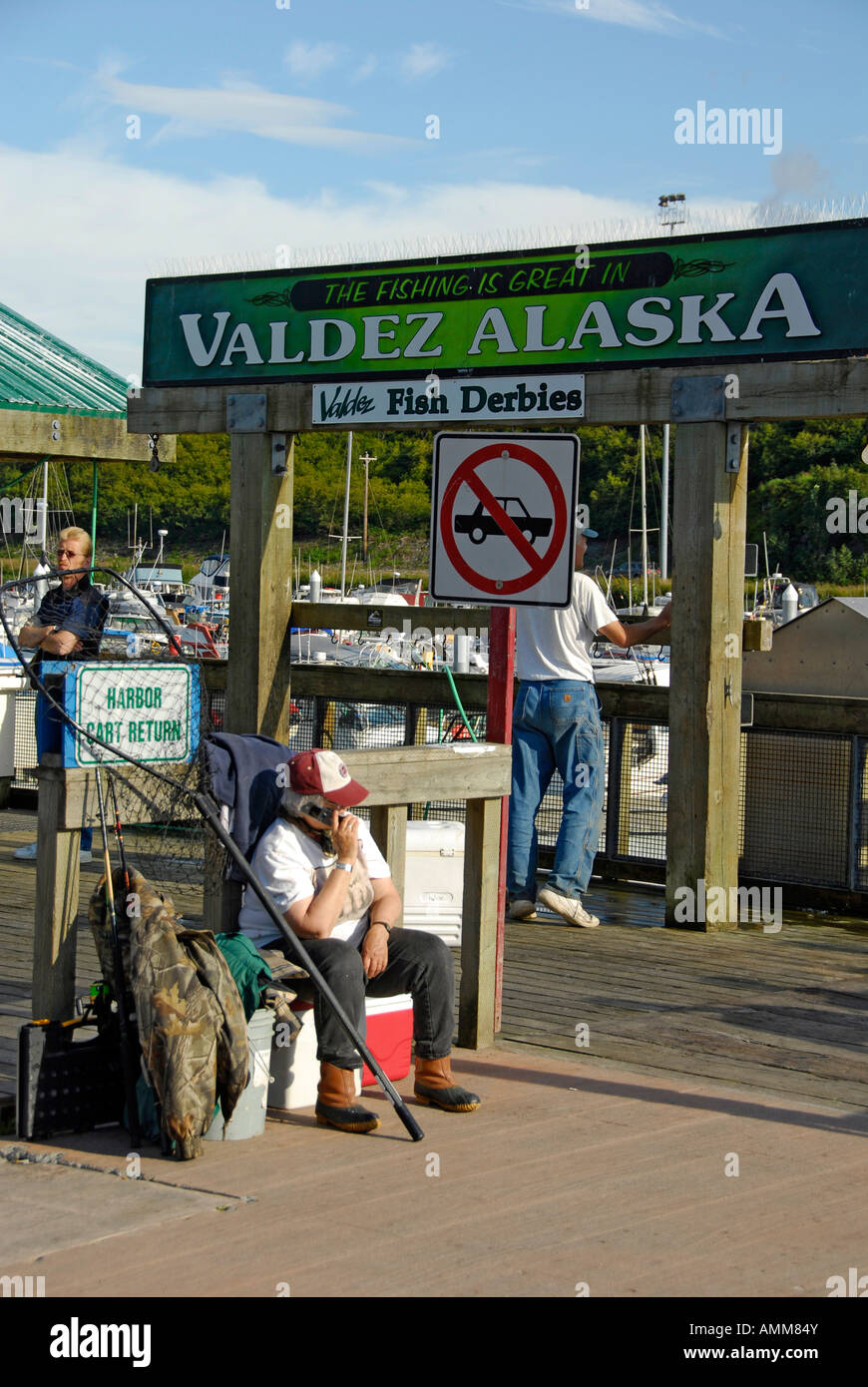 Fisherman talking on cell phone in Port Valdez Prince William Sound ...