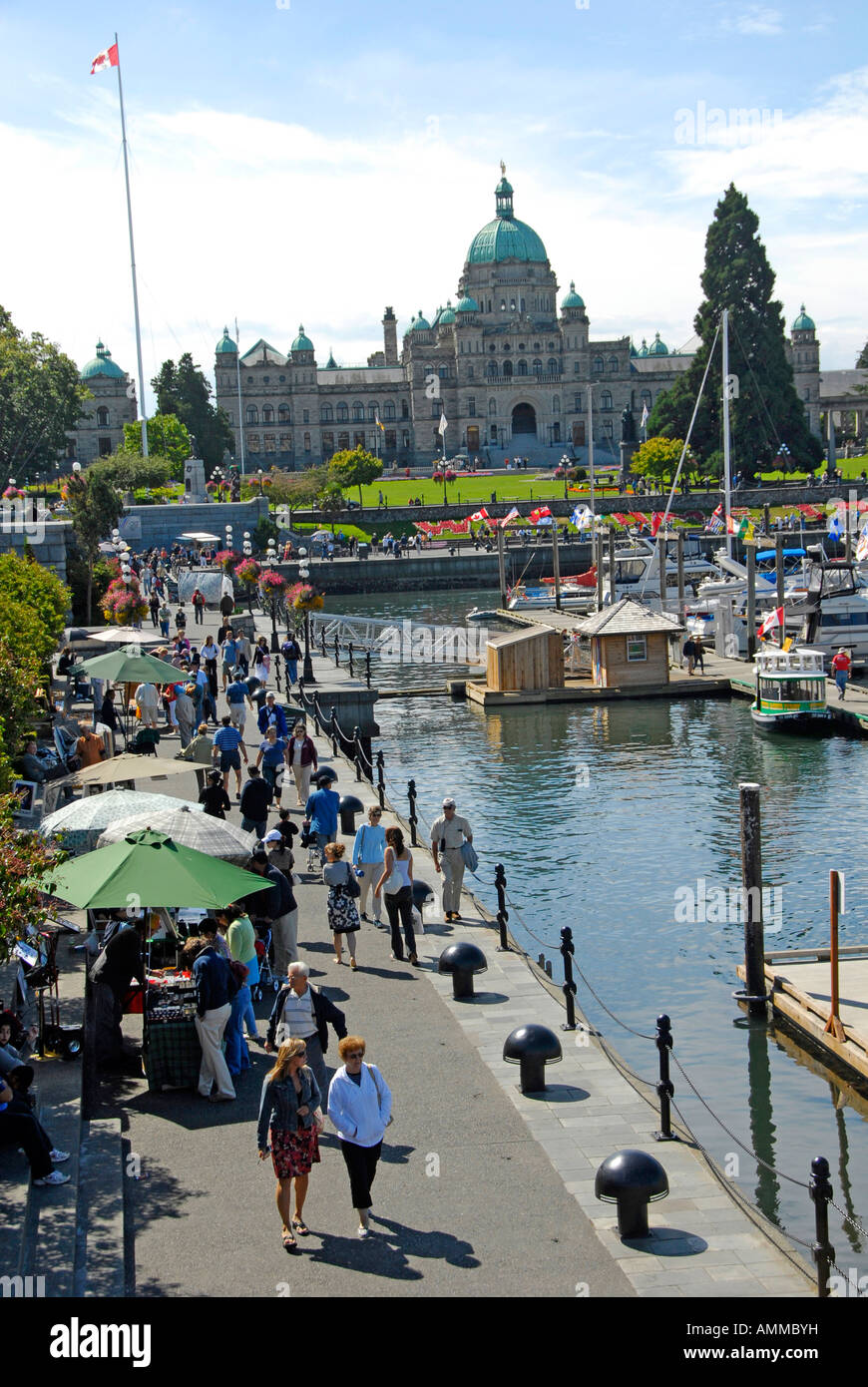 Tourists walk along Victoria Inner Harbour Harbor British Columbia BC ...