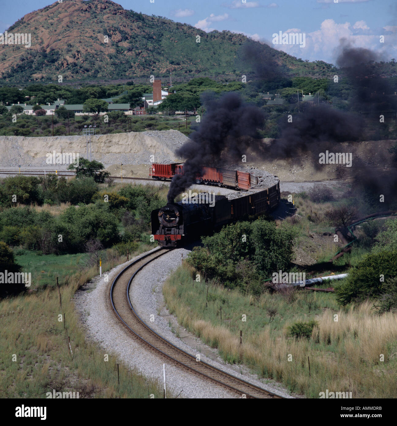 Steam engine pulling trucks of PGM ore body from mine to processing ...