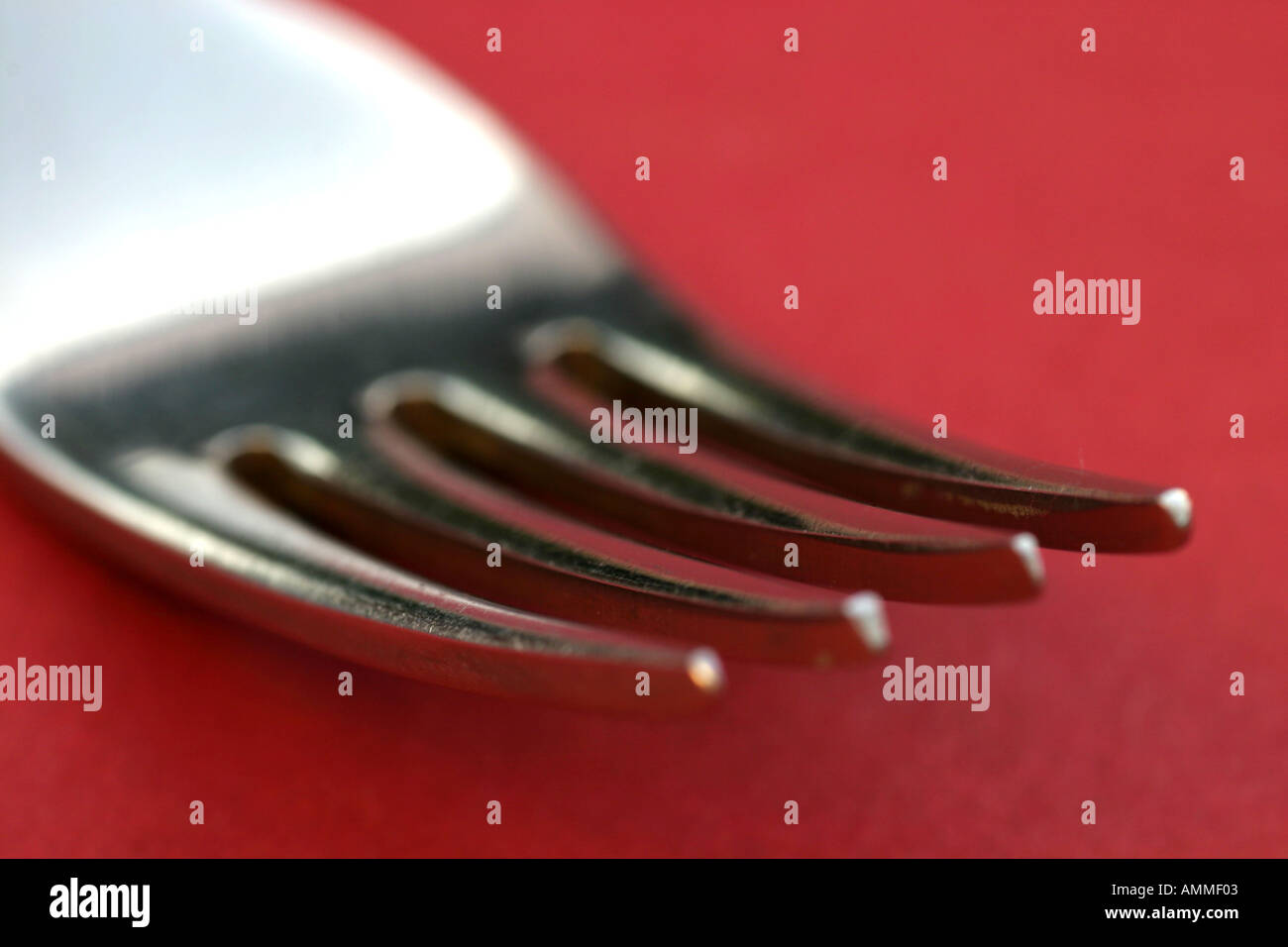 Fork with red background Stock Photo - Alamy