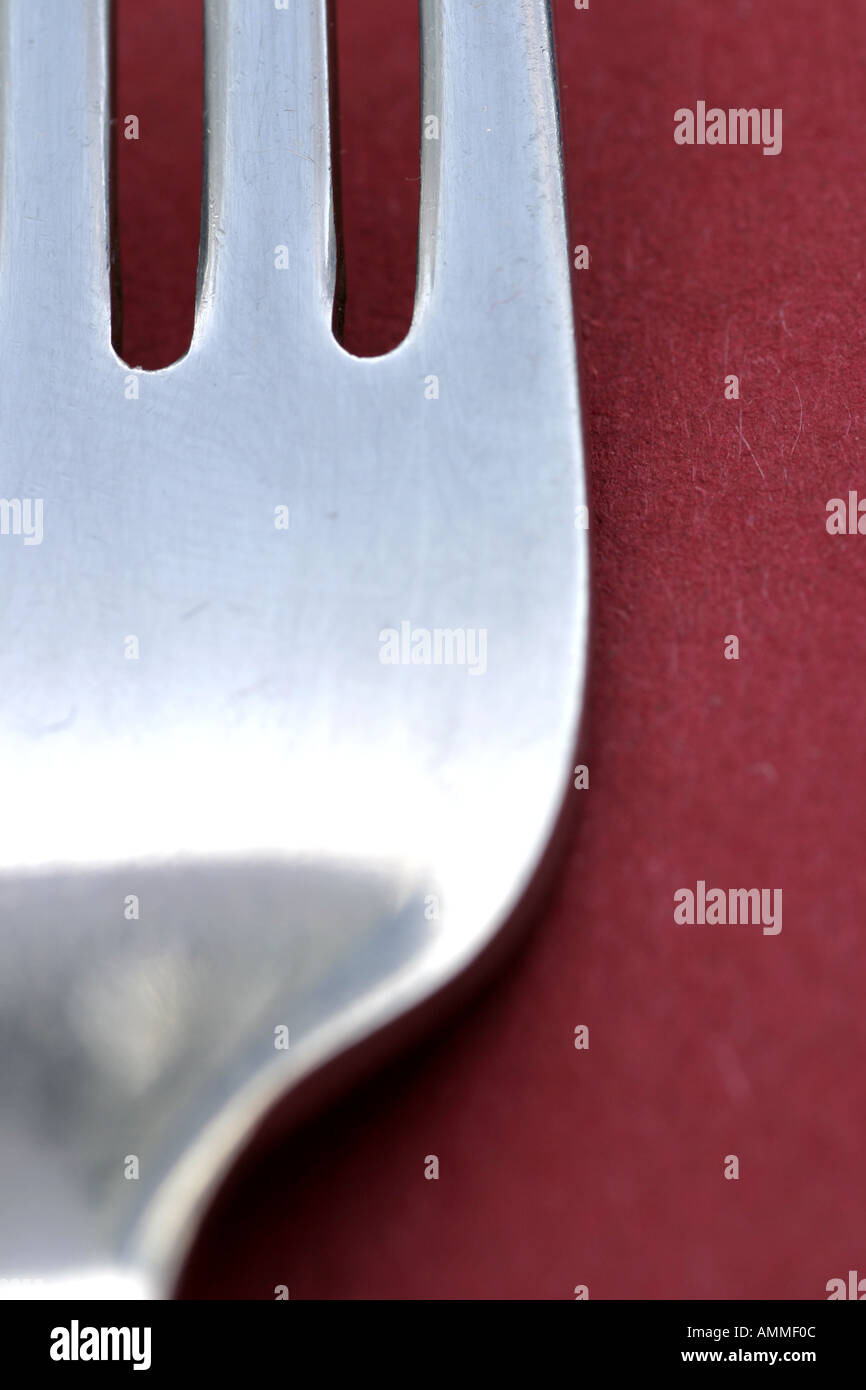 Fork with red background Stock Photo - Alamy
