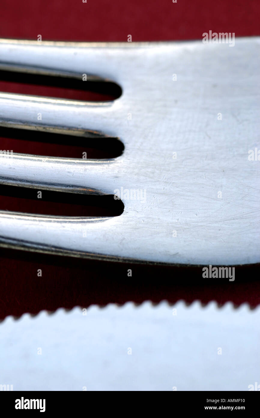 Knife and fork with red background Stock Photo - Alamy