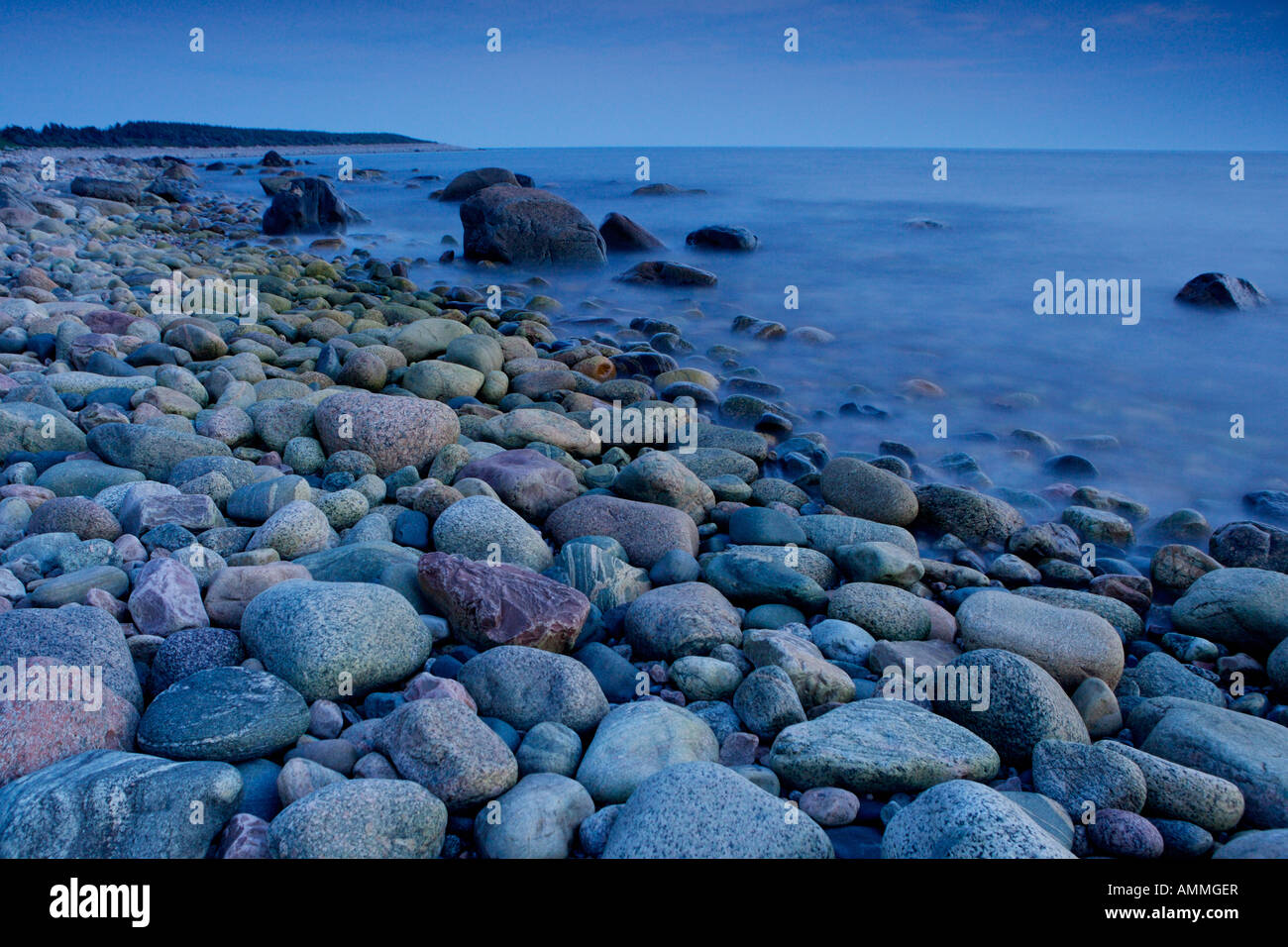 The rocky shoreline of Green Point at sunset, Northern Peninsula ...