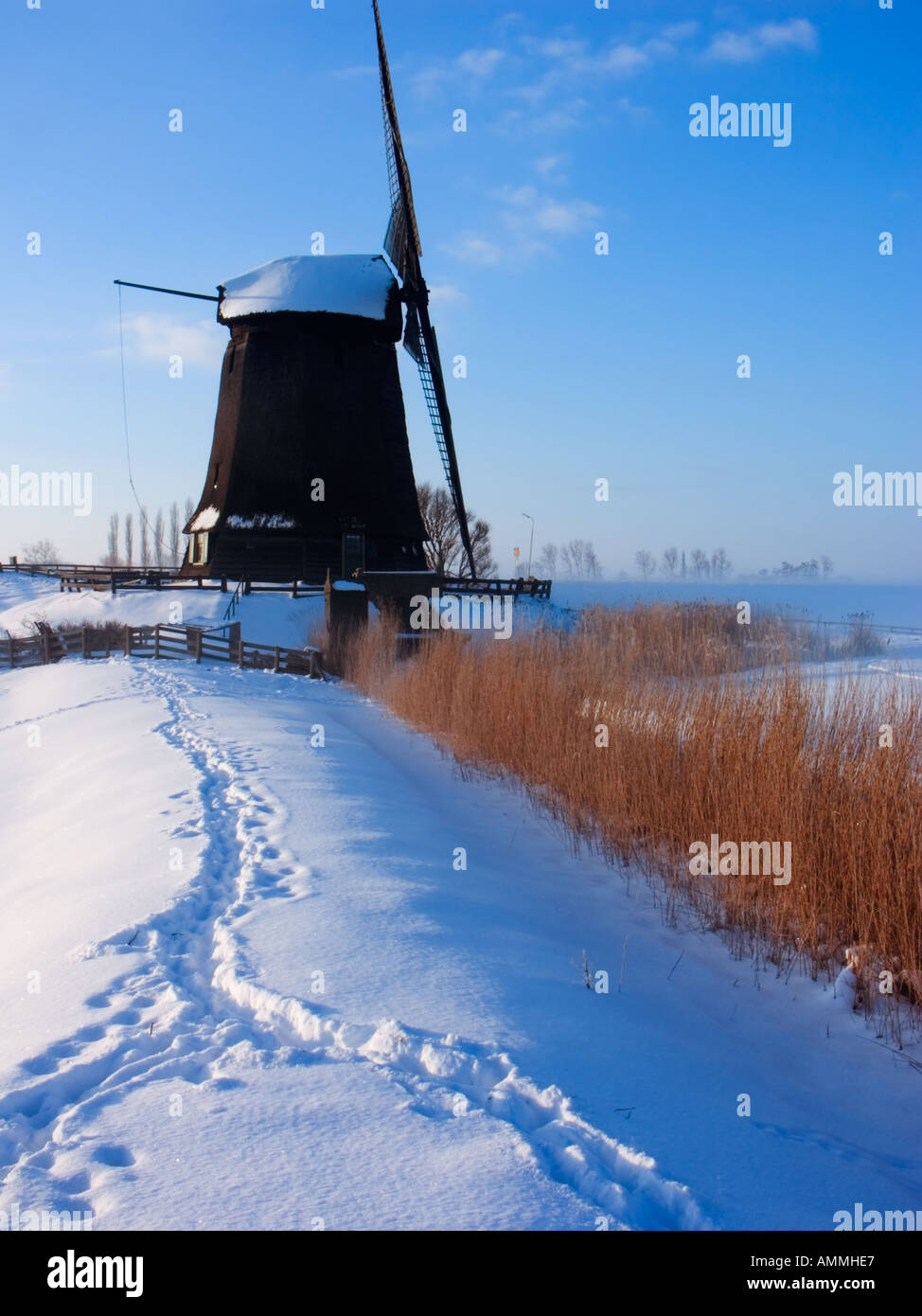 Windmill in winter landscape Stock Photo - Alamy