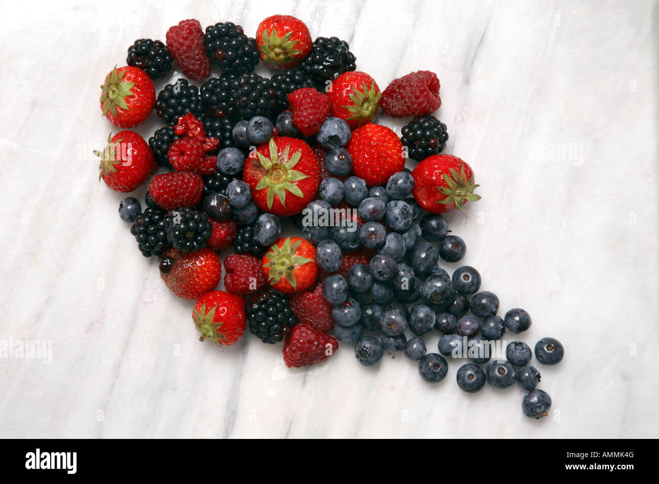 Berries on a slab of marble Stock Photo - Alamy