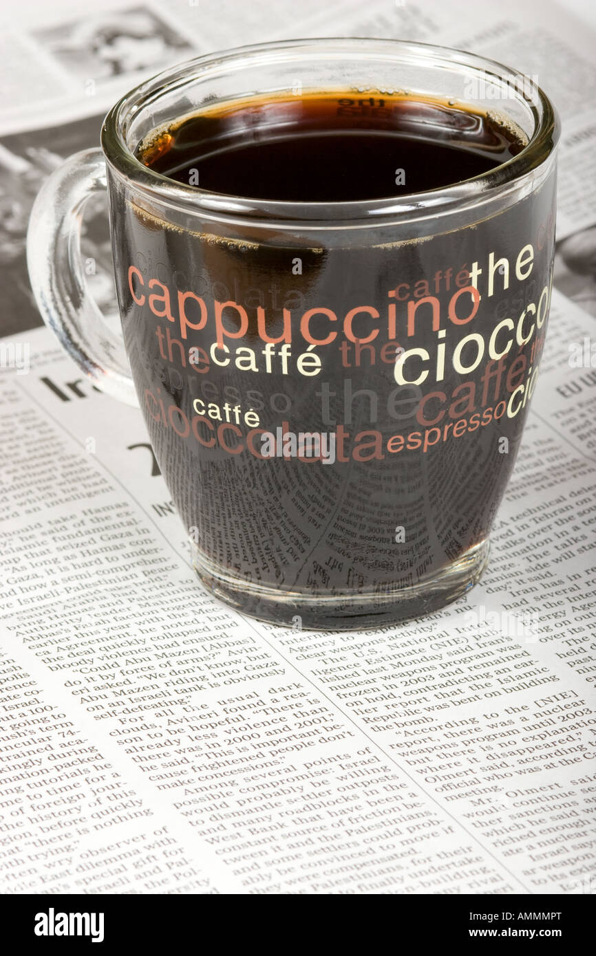 A transparent glass cup of coffee over a newspaper Stock Photo - Alamy