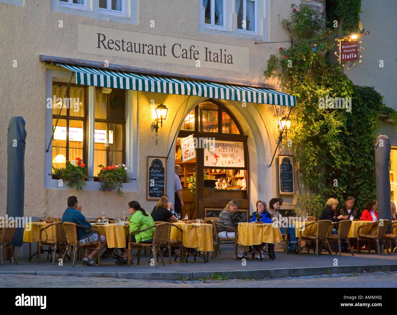 Italian restaurant with tables on pavement at dusk Rothenburg ob der ...