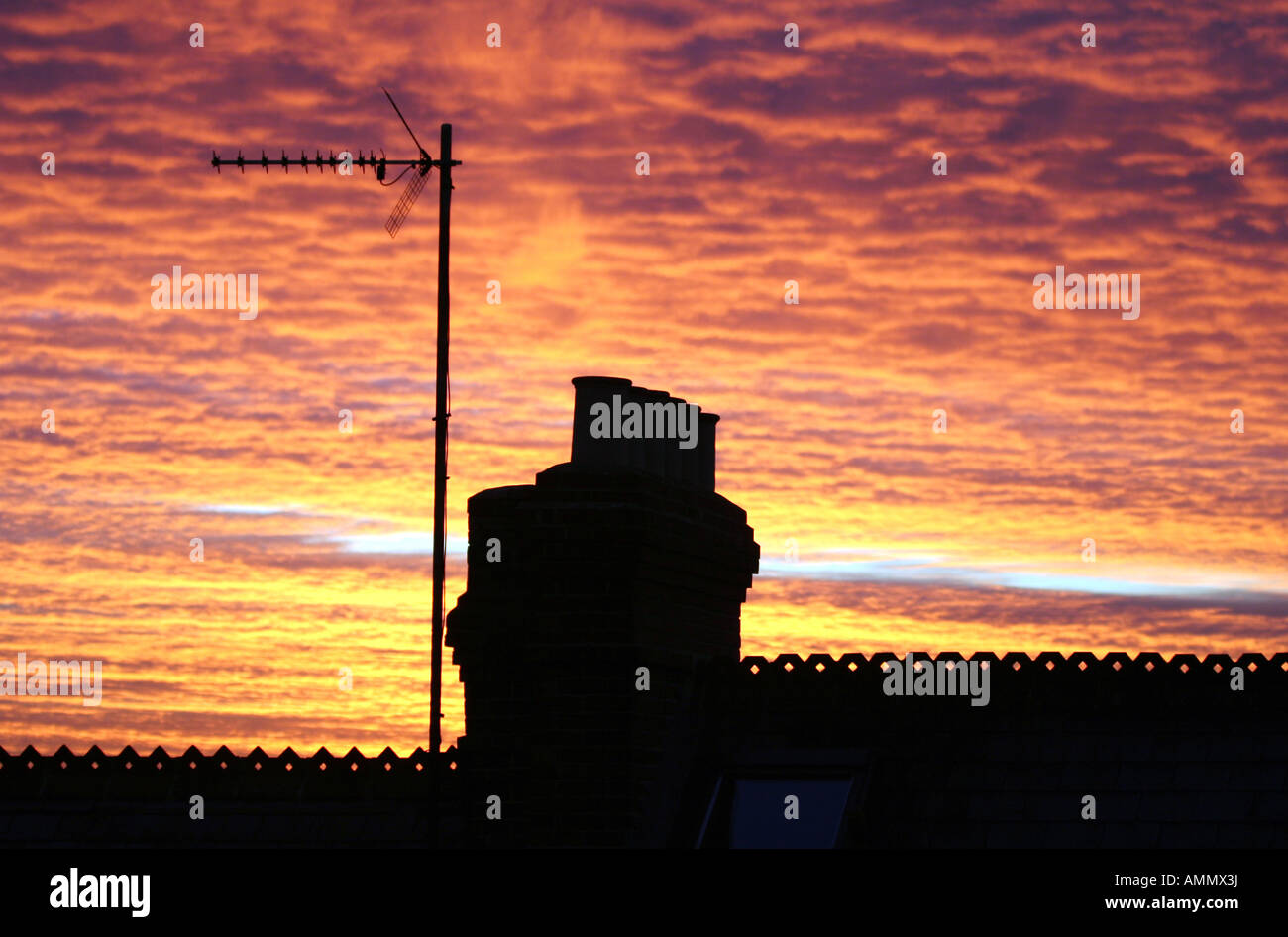 Sunrise over suburban roof, with television aerial Stock Photo - Alamy
