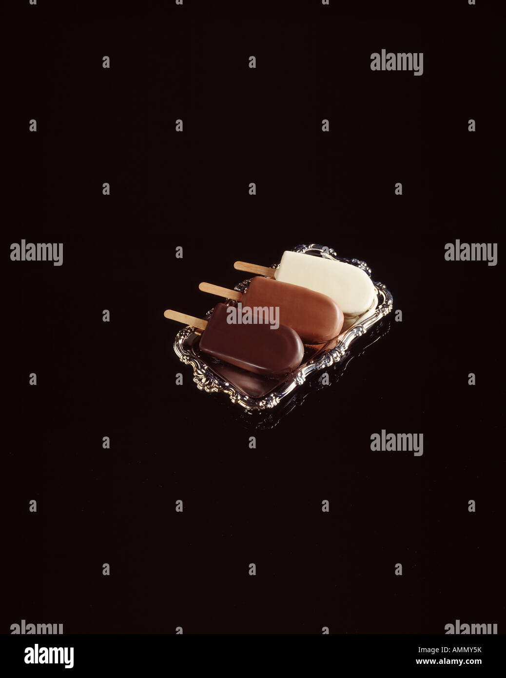 three rich chocolate coated ice cream popsicles white dark fudge ...