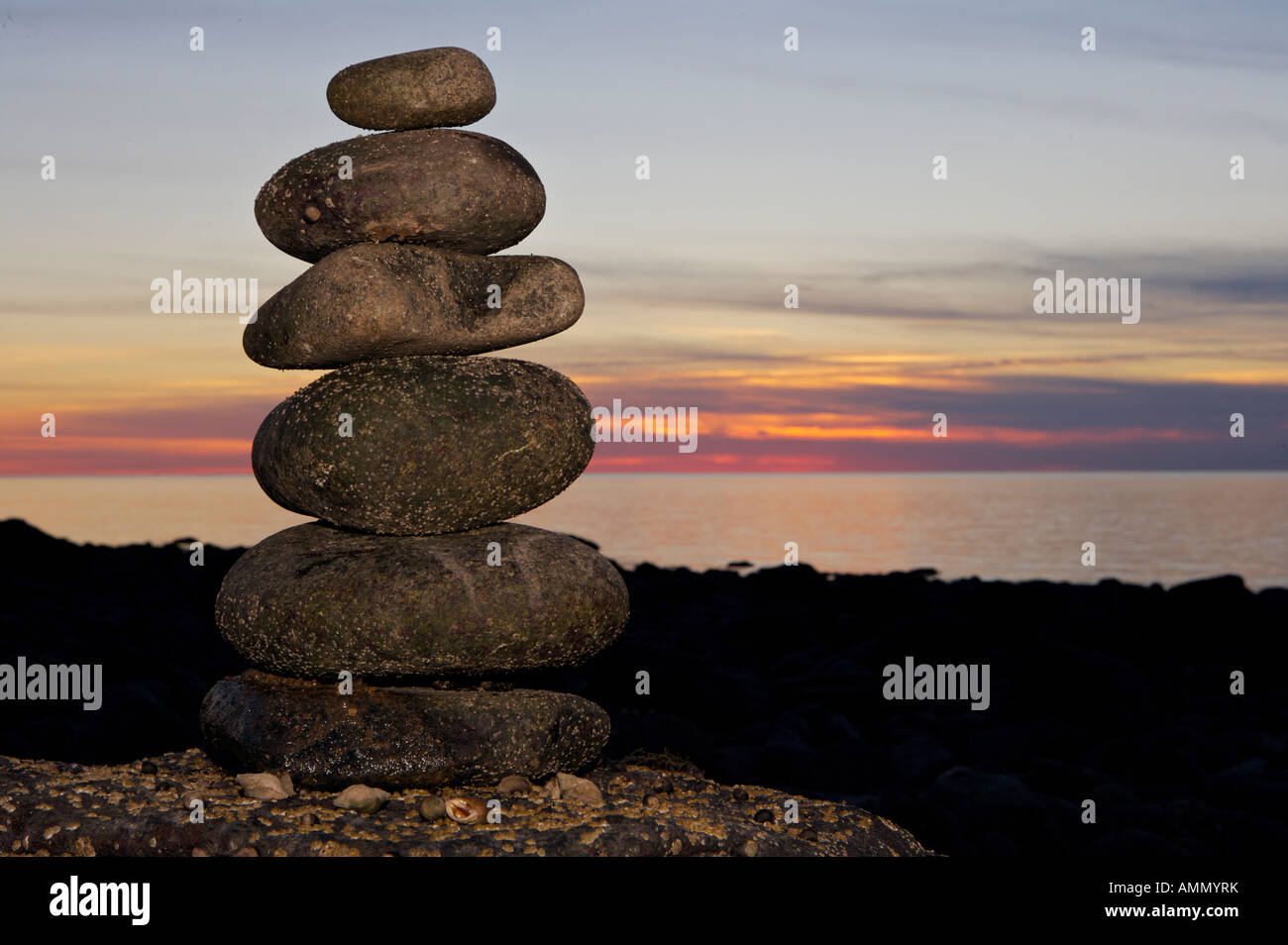 Stone formation along the beach at Delaps Cove during sunset over the ...