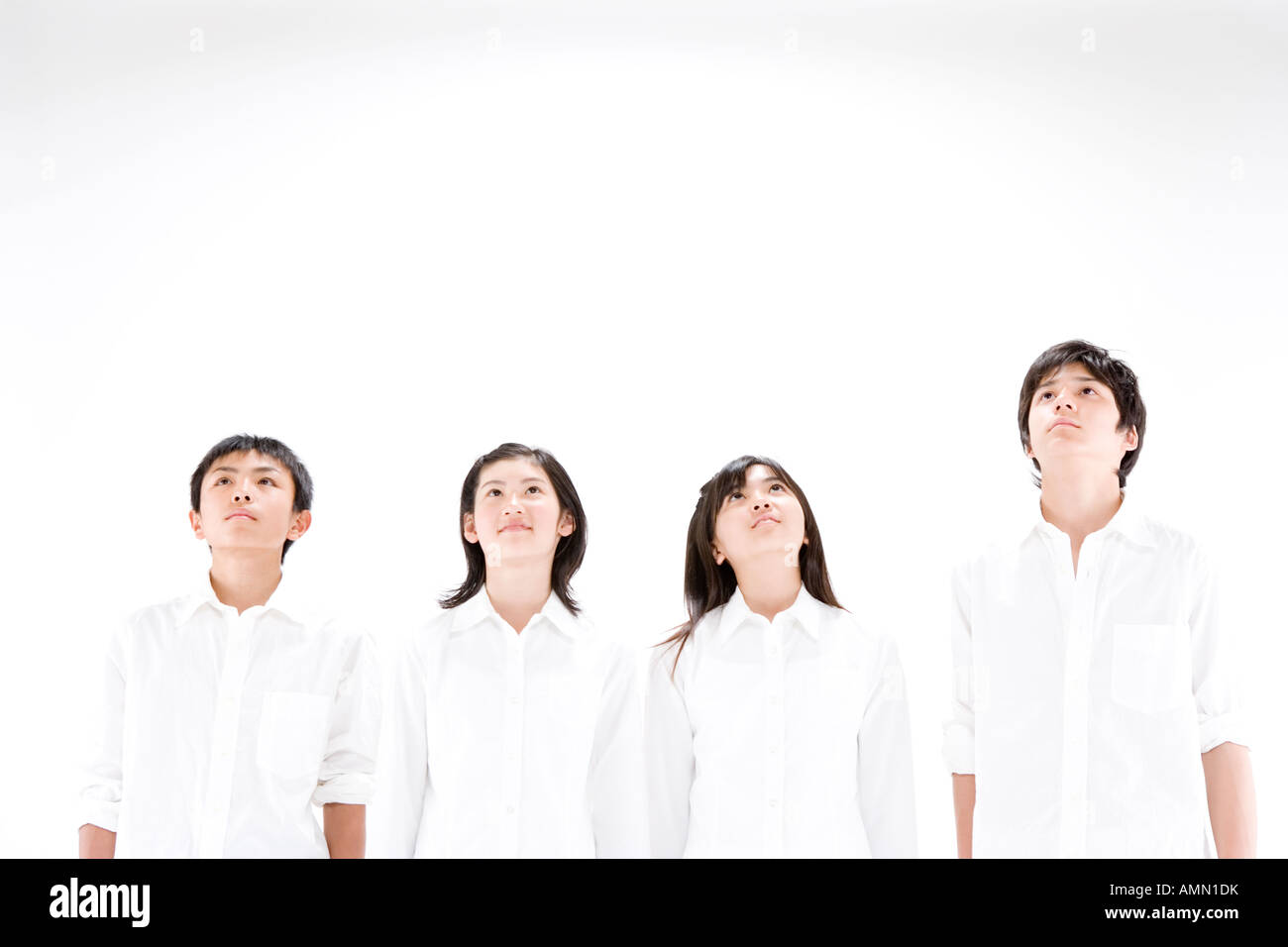 Four middle school students looking up Stock Photo - Alamy