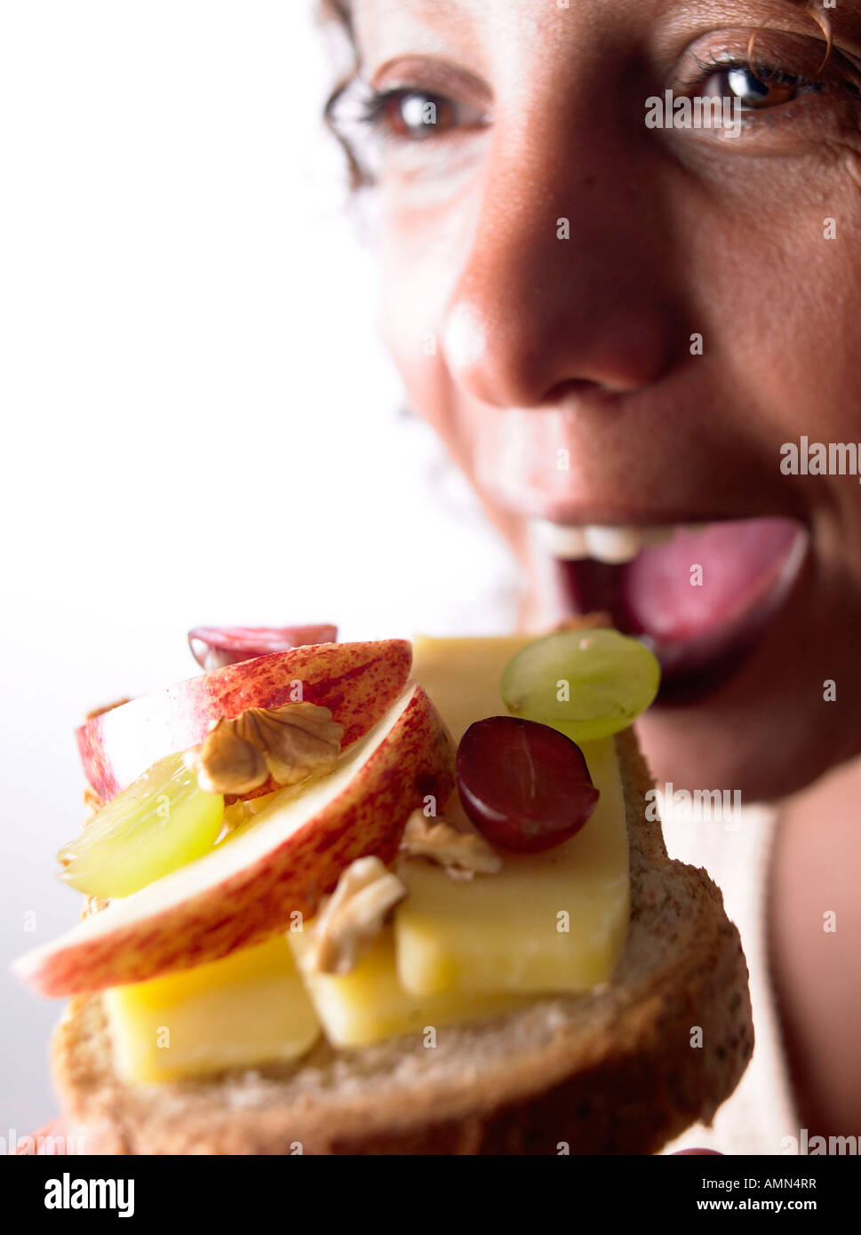 Girl eating an open sandwich Stock Photo - Alamy
