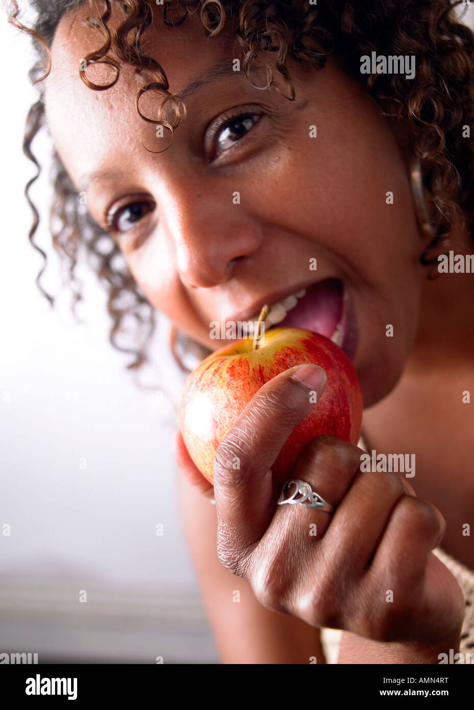 Girl eating an apple Stock Photo - Alamy
