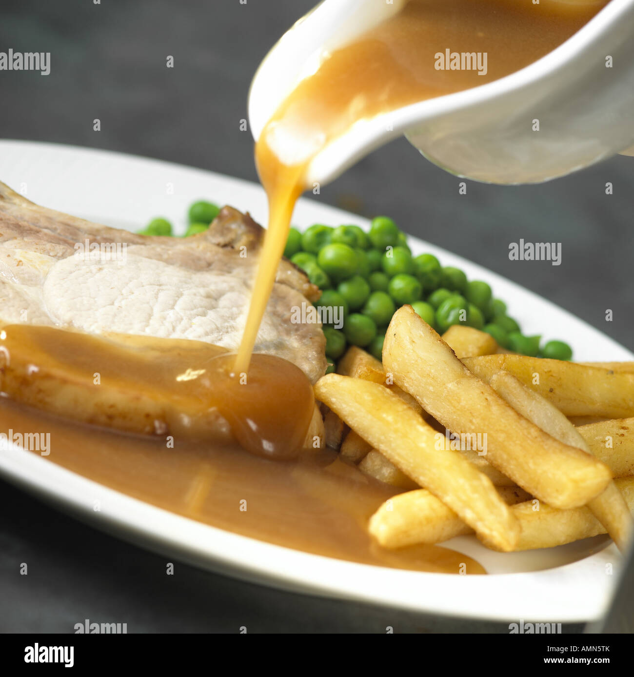 Pork, chips and gravy Stock Photo - Alamy