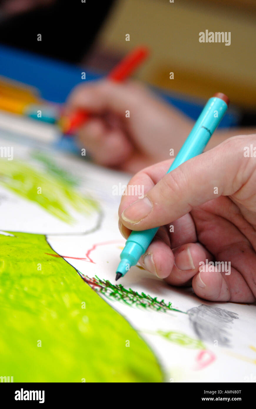 Colouring pens in the hands of artists at work Stock Photo - Alamy