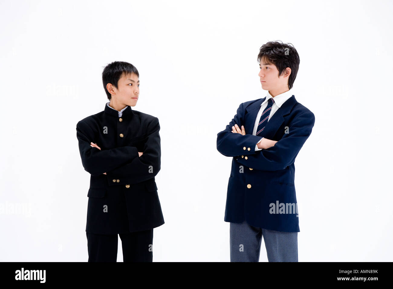 Two teenage boys looking each other Stock Photo - Alamy