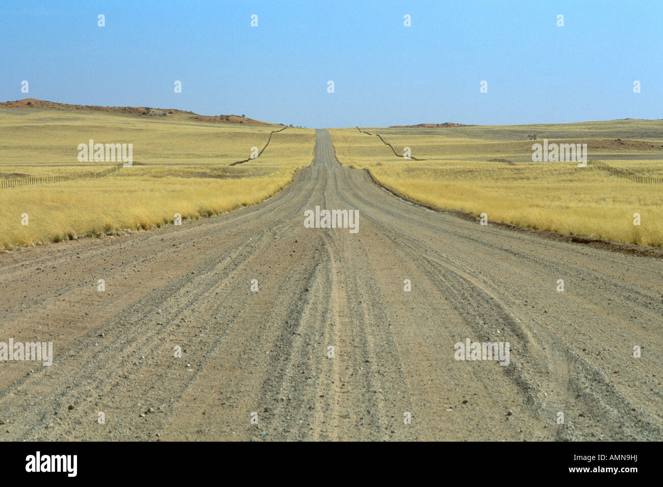 A grey sand road stretching to the horizon in the south of Namibia ...