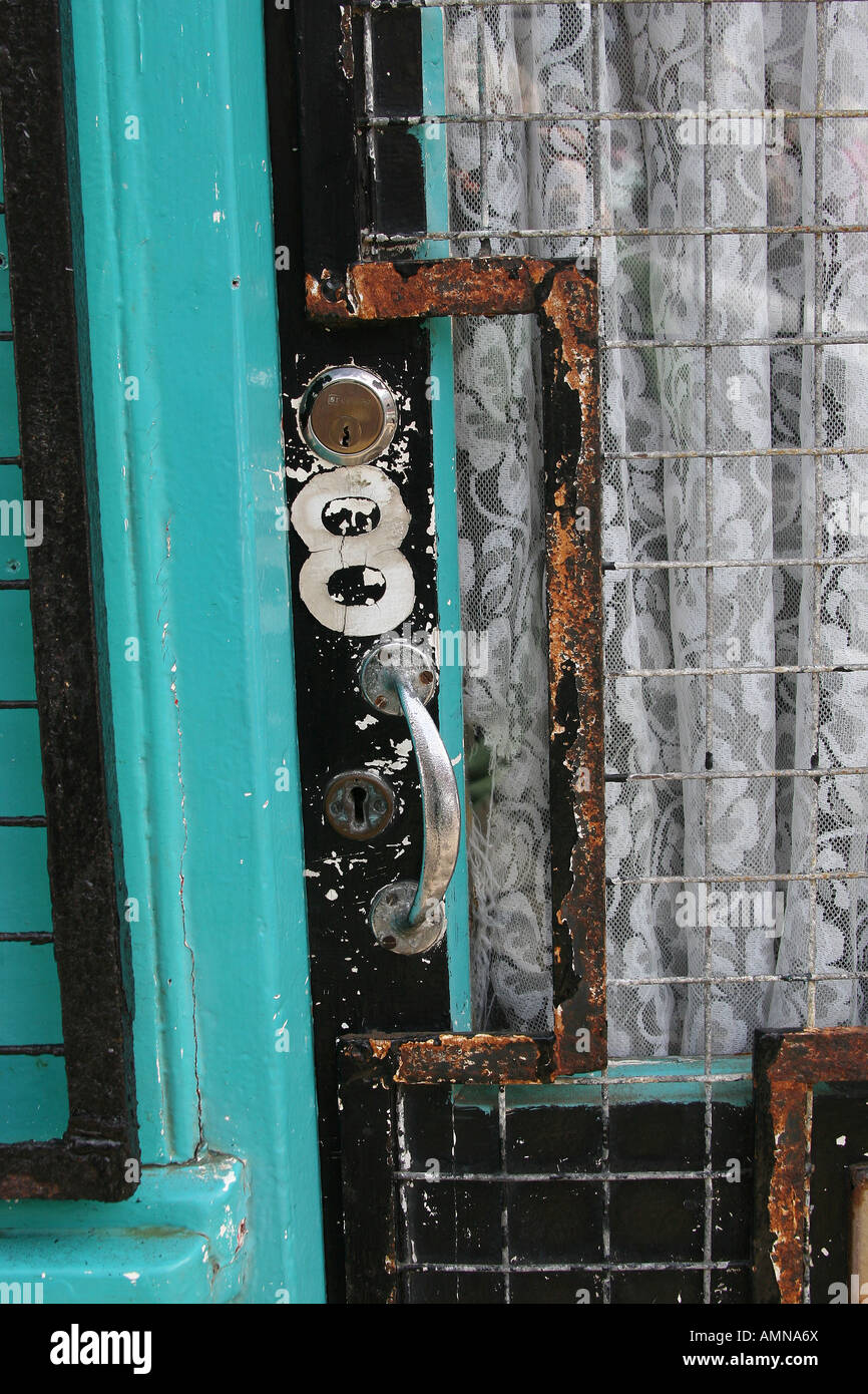 Old door with rusting security screens in place Stock Photo - Alamy