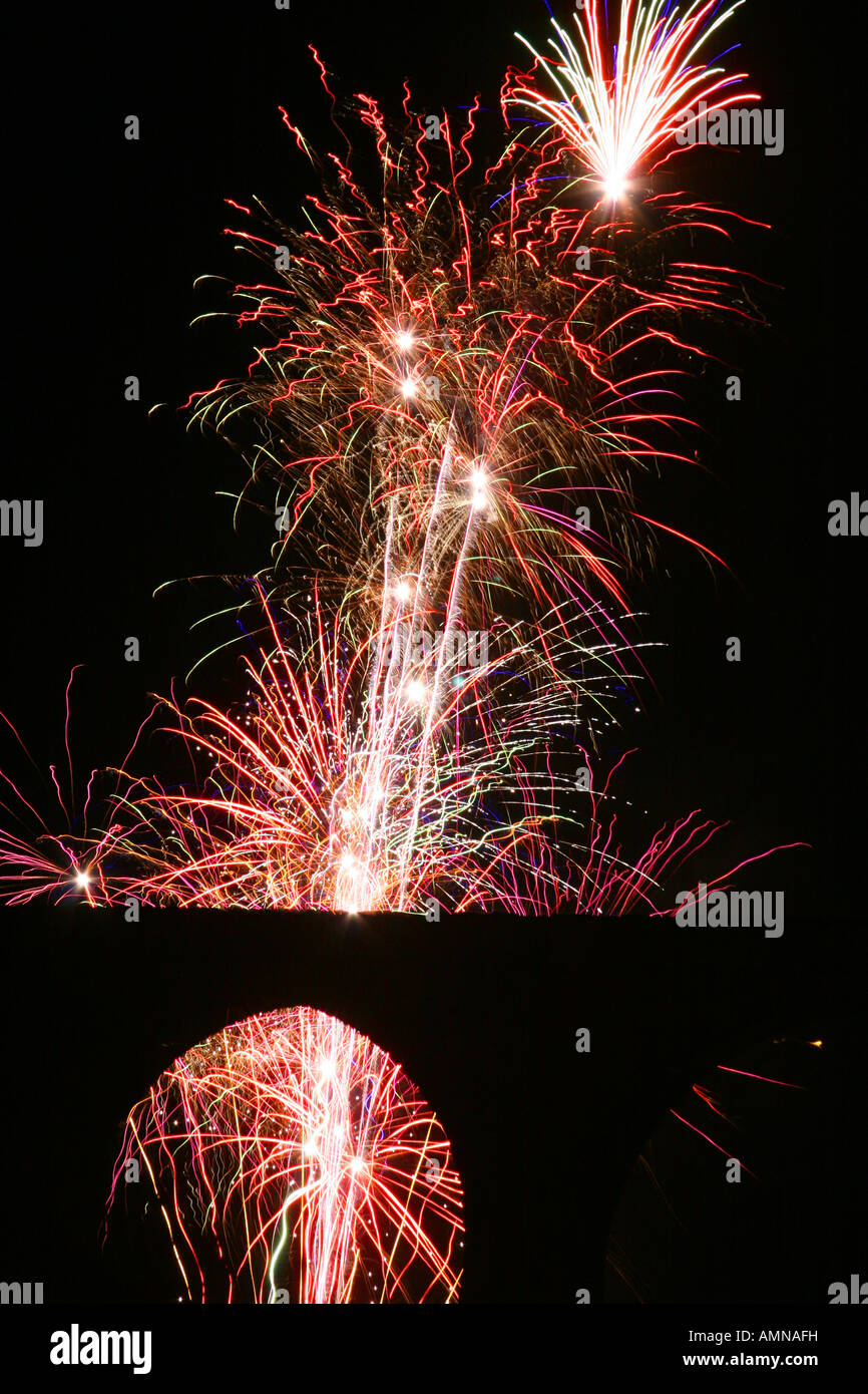 Fireworks bursting in dark sky above a viaduct arch Stock Photo - Alamy