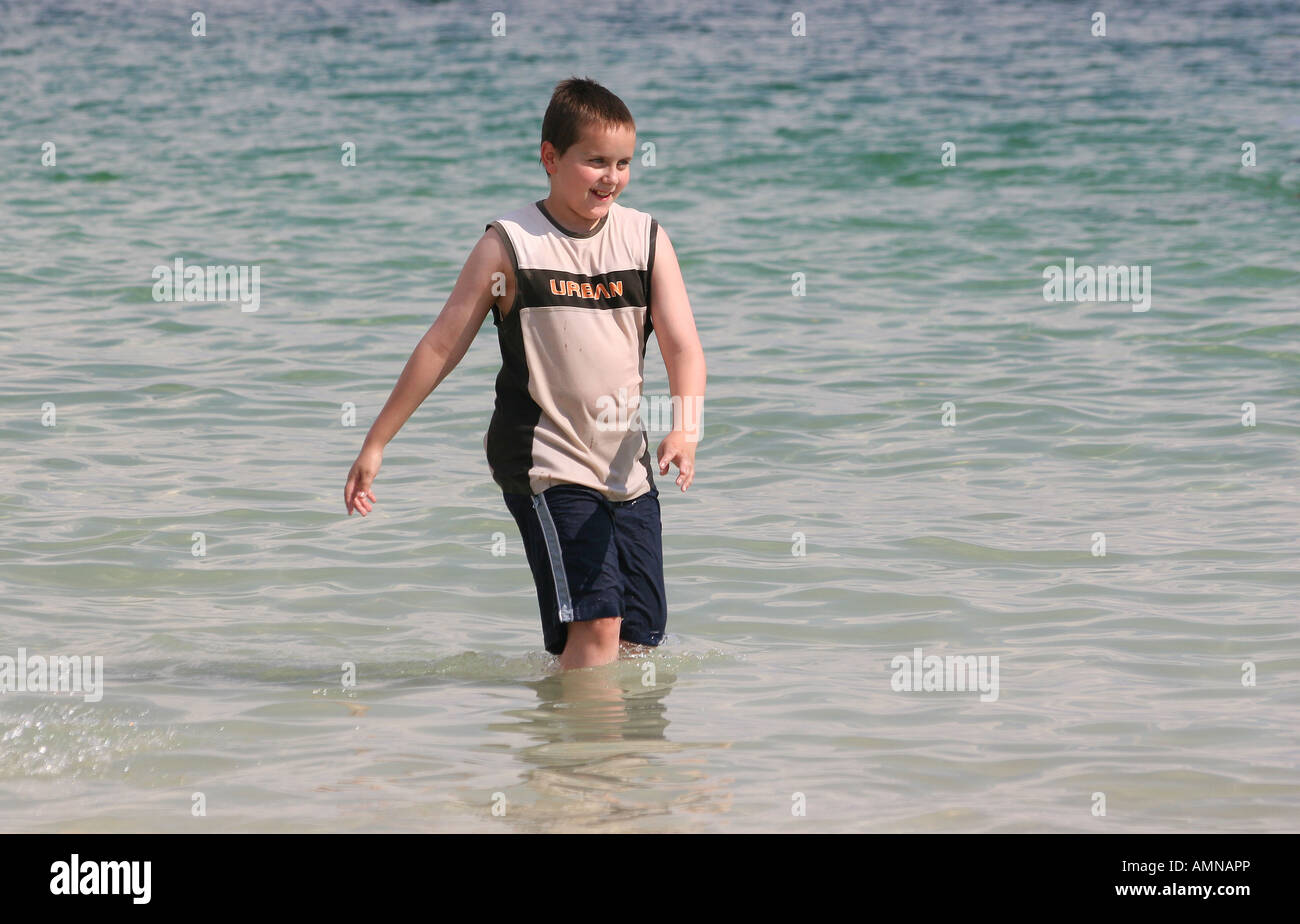 Young boy wading in the sea in shallow water at Palma Nova Stock Photo ...