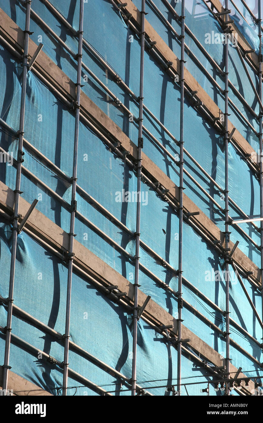 Complex scaffolding on the front of a glass faced building Stock Photo ...