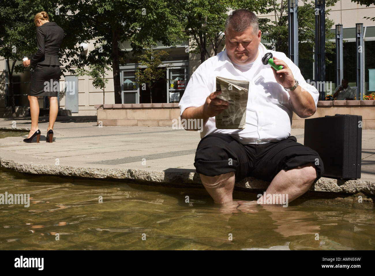 Fat man reading newspaper hi-res stock photography and images - Alamy