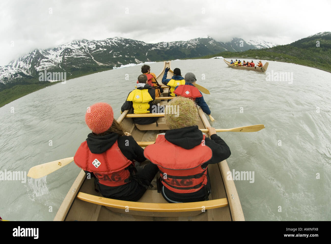 ALASKA SPENCER GLACIER PEOPLE PADDELING ESKIMO CANOES ON GLACIER LAKE ...