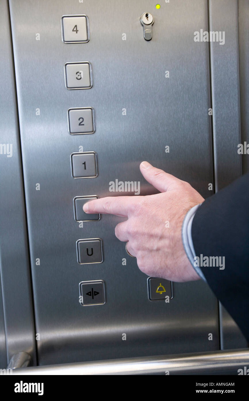 Hand pushing an elevator button Stock Photo - Alamy