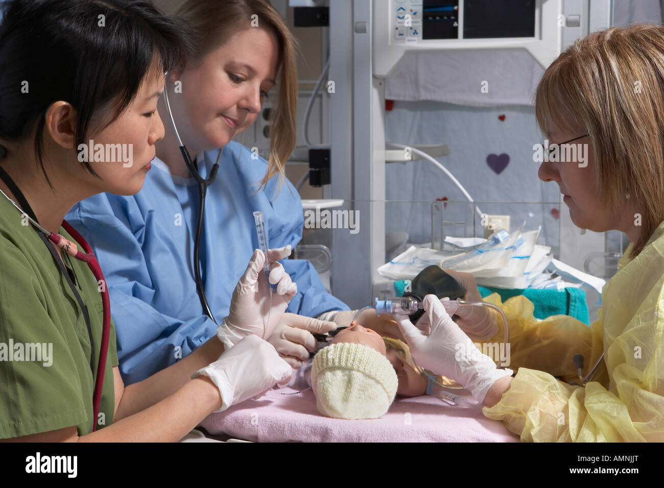 Nurses Practicing on Baby Mannequin Stock Photo - Alamy