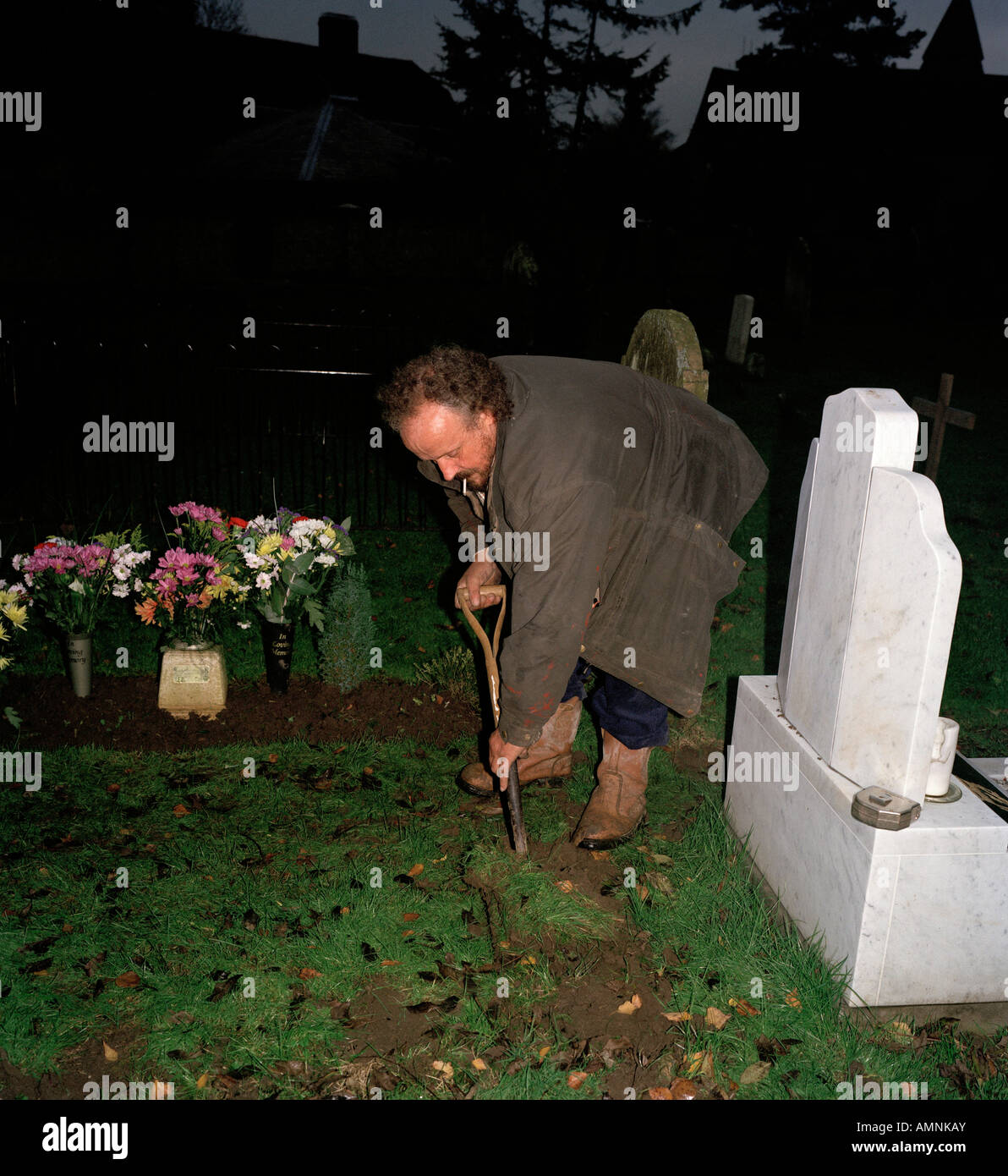 Gravedigger digging a new grave Stock Photo - Alamy