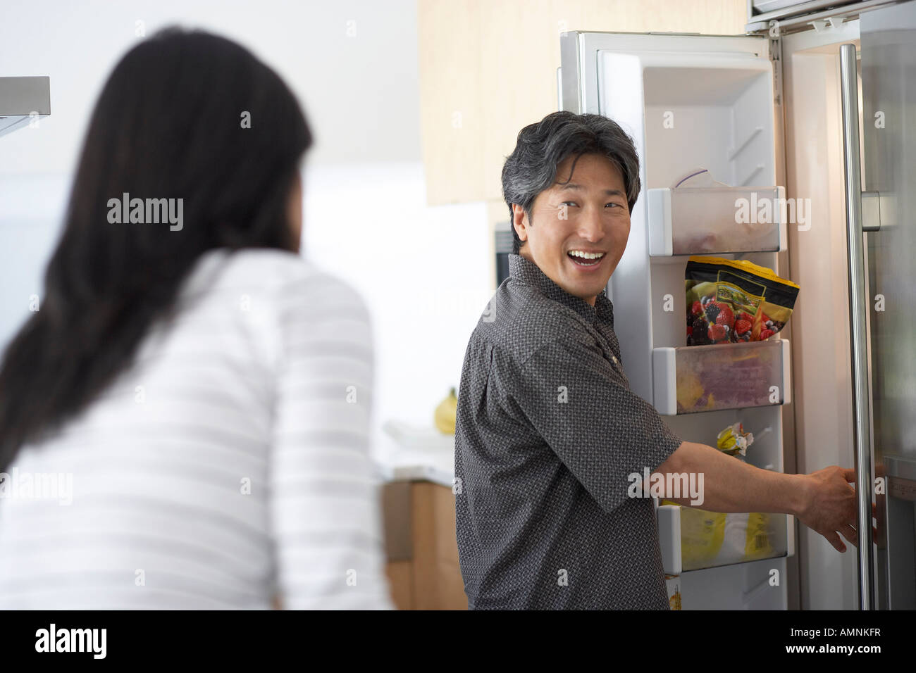 Middle aged man opening refrigerator hi-res stock photography and ...