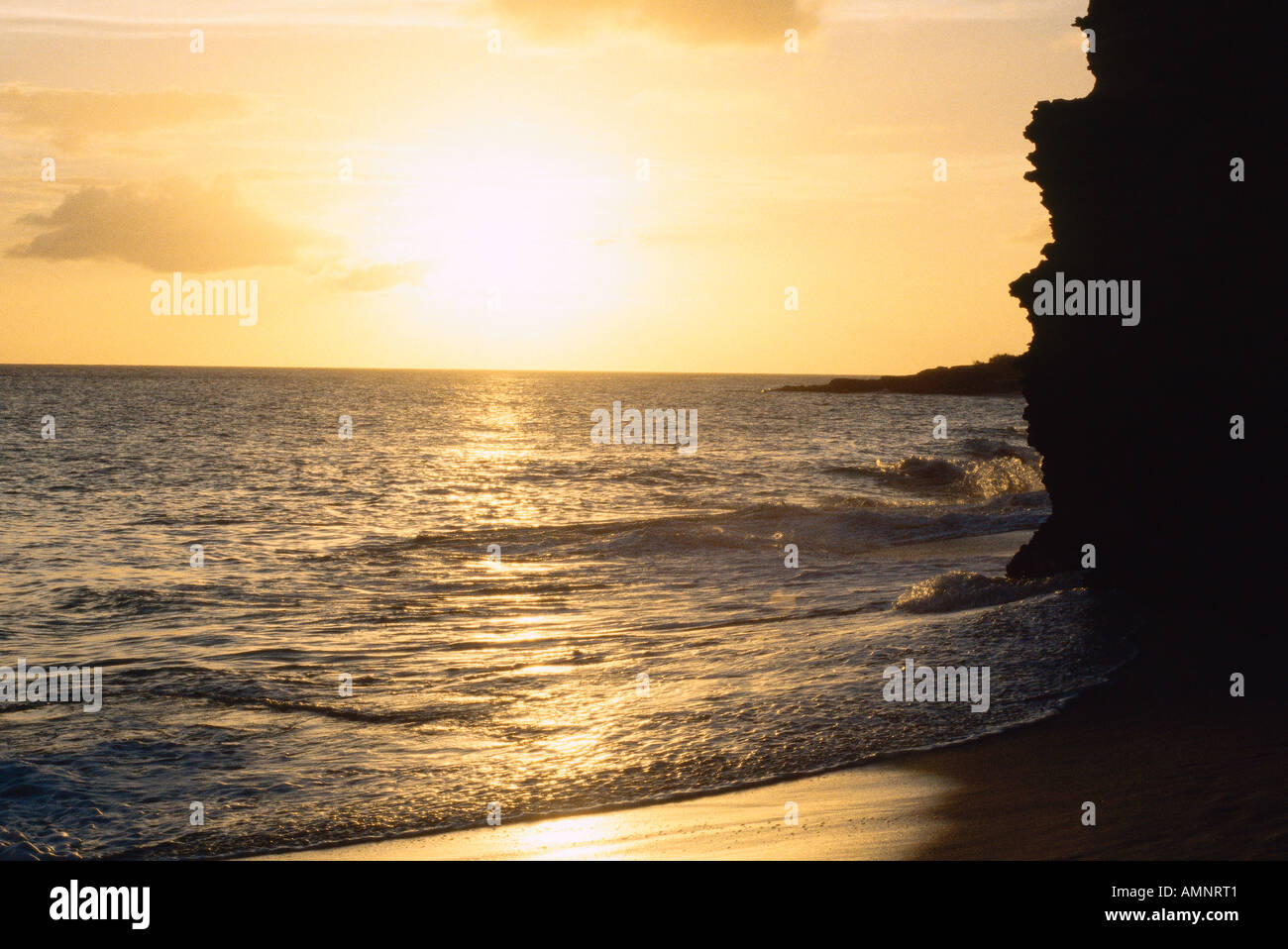 Sunset over Water and Beach Stock Photo - Alamy