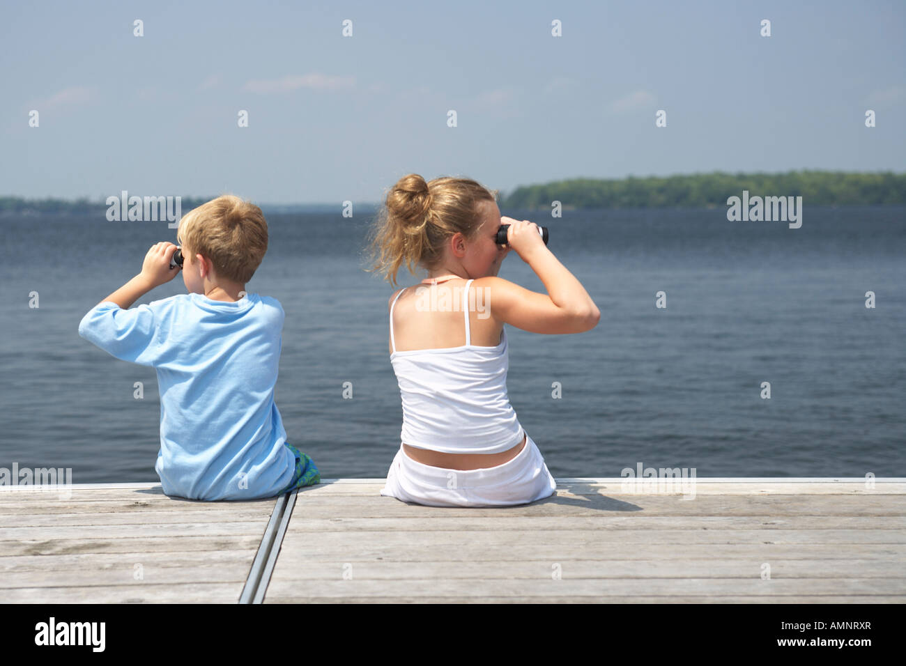 Boy And Girl Sitting On Dock High Resolution Stock Photography and ...