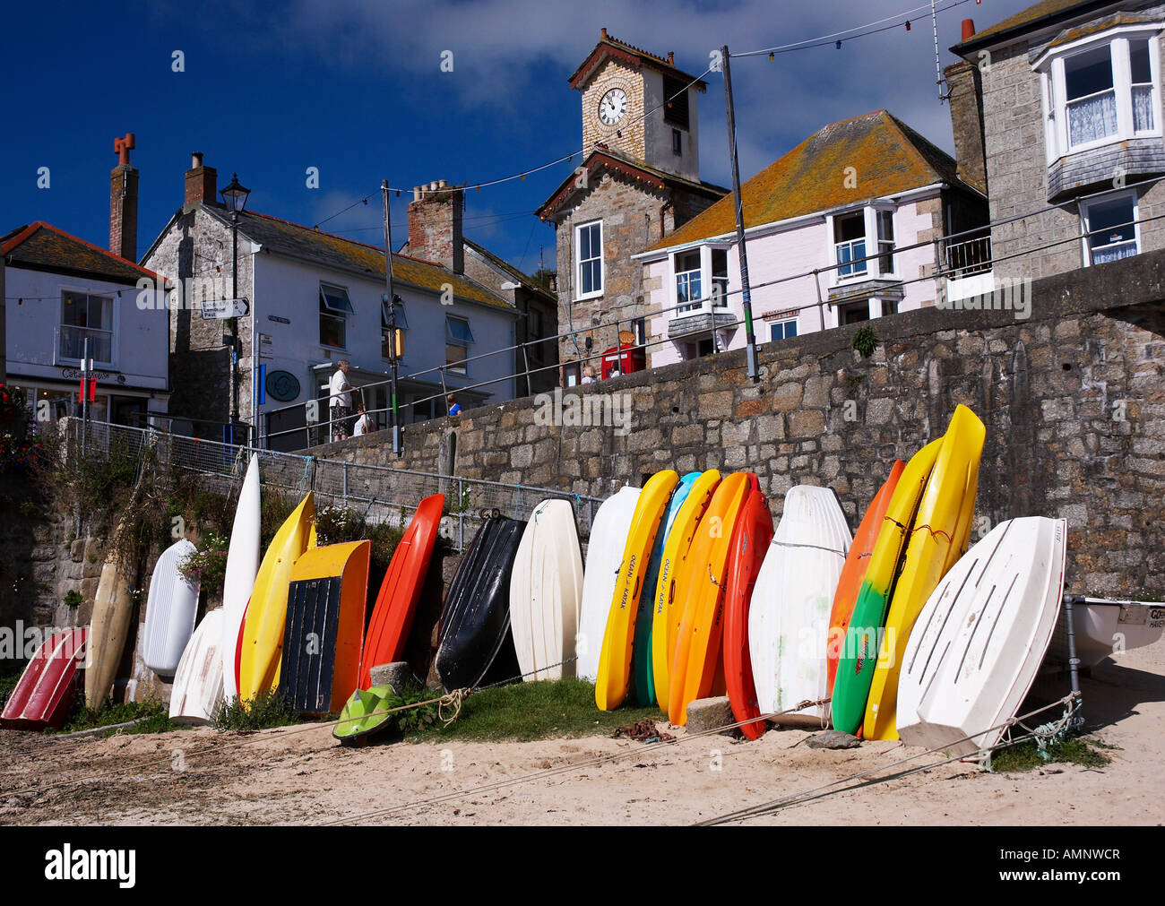 A beautiful summer scene of colourful boats propped up against the ...