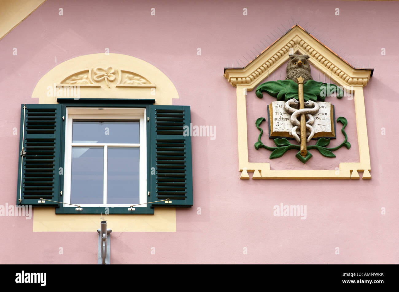 Baroque window with an old apothecary crest on a traditional Austrian ...